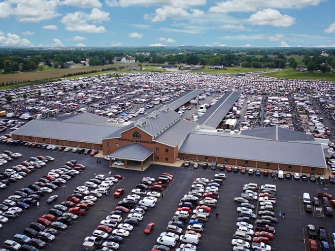 The treasure hunt begins! Shoppers stroll through outdoor vendor aisles at Hartville, where one person's castoffs become another's prized finds.
