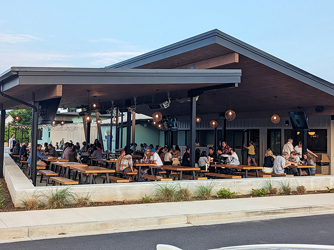 Communal tables under string lights&mdash;where strangers become friends united by the universal language of perfectly smoked meat.