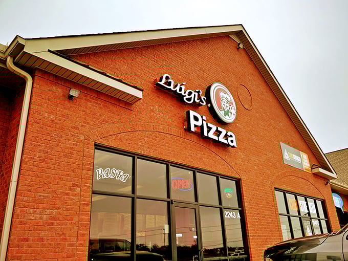 A closer look at Luigi's Pizza sign—where every pie tells a story. That classic Italian chef logo practically whispers "trust me with your dinner plans."