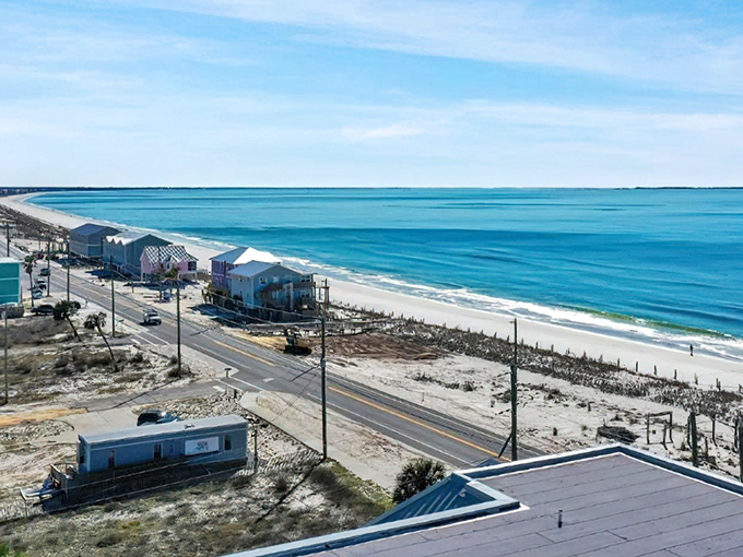 Where beachfront homes stand like colorful sentinels along the shore. The Gulf stretches endlessly blue, promising perfect swimming conditions.
