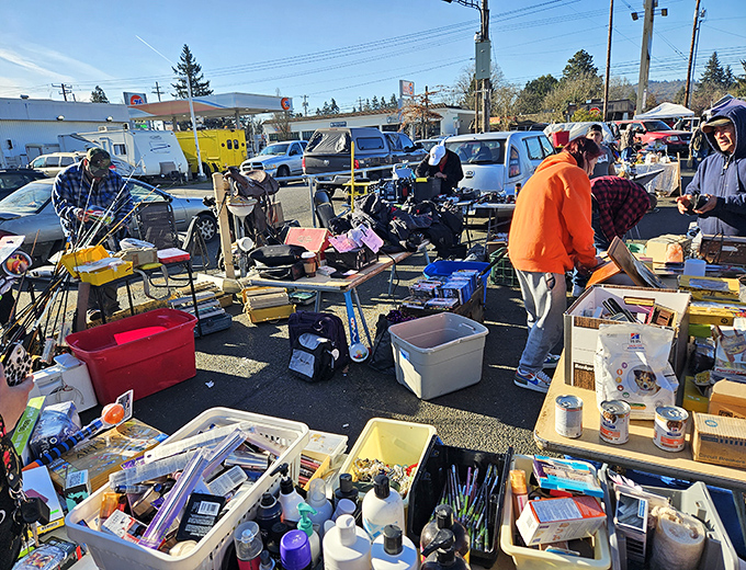 The thrill of the hunt! Tables overflow with potential treasures as shoppers scan for that perfect something they didn't know they needed.