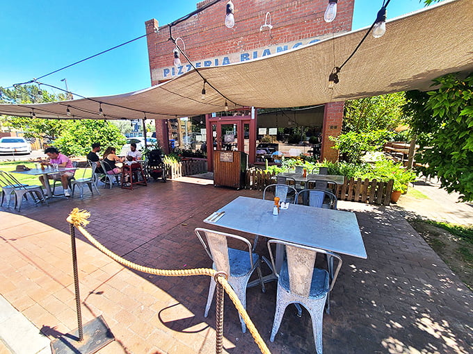 The shaded patio at Pizzeria Bianco offers the perfect spot to savor award-winning pizza while soaking in Phoenix's beautiful weather.