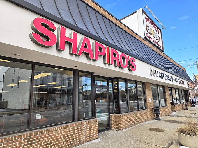 The bold red lettering of Shapiro's Delicatessen beckons like a lighthouse for the sandwich-starved, guiding hungry souls to pastrami paradise.