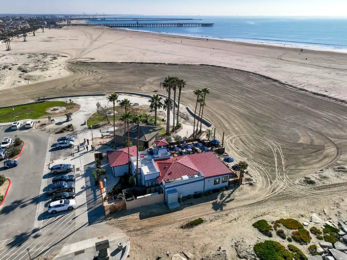 A beachfront paradise where the parking lot meets the sand. From this aerial view, you can almost hear the waves calling your name.