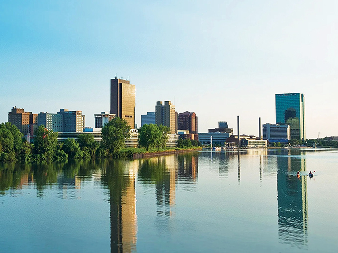 Morning light dances across Toledo's waterfront, where city meets river. The Glass City's reflection shimmers like a budget-friendly mirage of urban possibility.