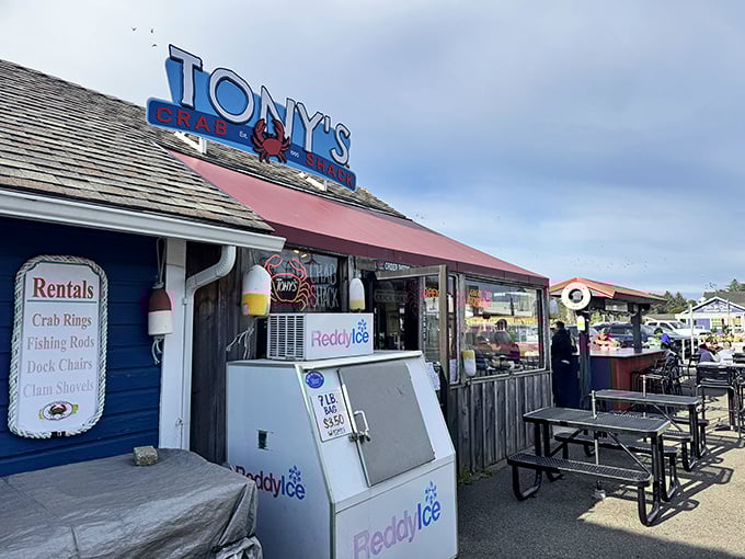 That cheerful red awning promises fresh crab and ocean views &ndash; no fancy tablecloths required, just pure coastal goodness.