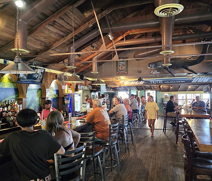 Inside, rustic wooden beams and mounted gators create that perfect "Old Florida" vibe where conversations flow as freely as the drinks.