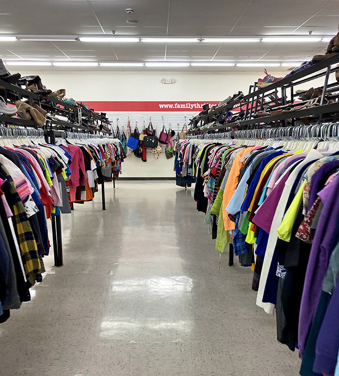 Endless rows of colorful clothing create a textile treasure map where vintage gems hide in plain sight.