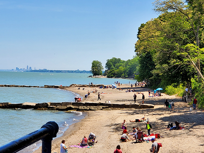 Beach day bingo! Colorful umbrellas dot the sand while Cleveland's skyline plays peekaboo in the distance&mdash;the best of both worlds.