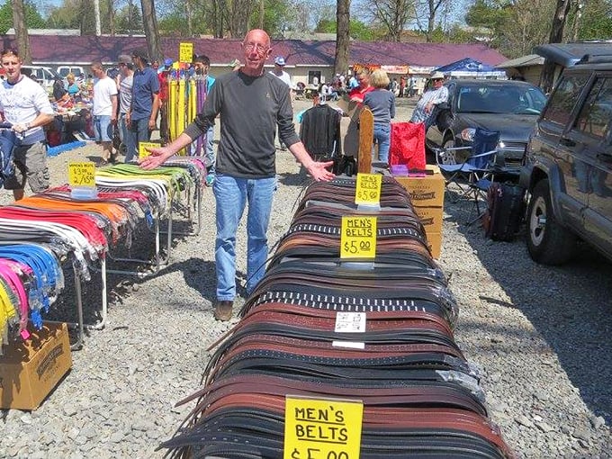 Men's belts cascade like leather rainbows, proving that even the most practical accessories deserve their moment to shine.