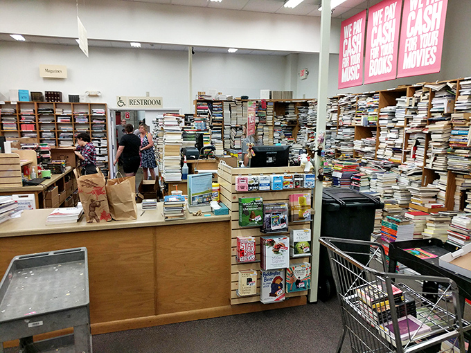 Behind this counter, literary dreams are processed daily. Note the towering stacks awaiting their turn to find new homes.