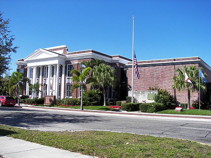 Old Florida elegance stands proud at Punta Gorda's historic City Hall, where palm trees and classical columns remind us that government buildings weren't always designed by accountants.