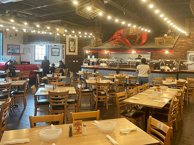 Wooden tables await beneath the watchful eye of a giant lobster sculpture, where countless bibs have witnessed moments of seafood euphoria.