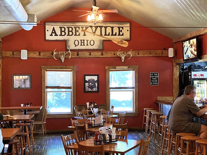 Inside, rustic charm meets Midwestern hospitality with the "Abbeyville, Ohio" sign watching over diners like a delicious guardian angel.
