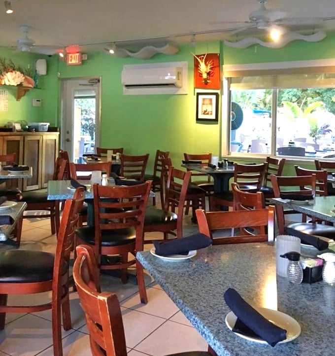 Green walls and wooden chairs create the perfect backdrop for serious lobster roll contemplation and coastal conversations.