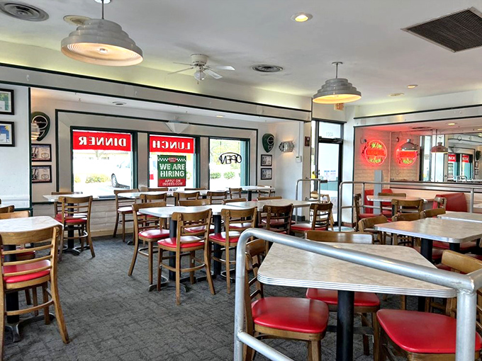 Simple wooden chairs and red vinyl seats create the perfect no-frills backdrop for the culinary star of the show&mdash;those legendary cheeseburgers everyone's talking about.