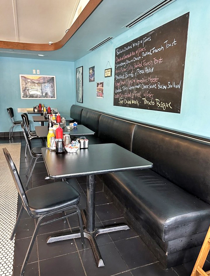 Black vinyl booths and a handwritten specials board – this isn't interior design, it's diner authenticity that no Pinterest board could ever replicate.