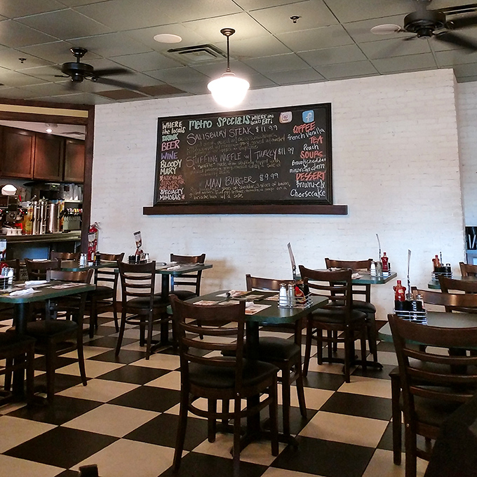 Classic black and white tiles that say "serious diner business happens here." The chalkboard menu promises specialties worth breaking your diet for.