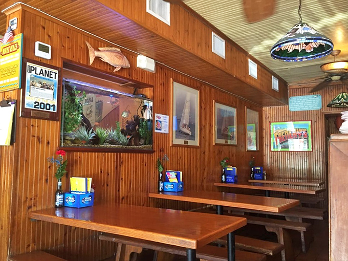 The dining room proves that comfort beats fancy every time &ndash; where wood paneling meets pure coastal satisfaction.