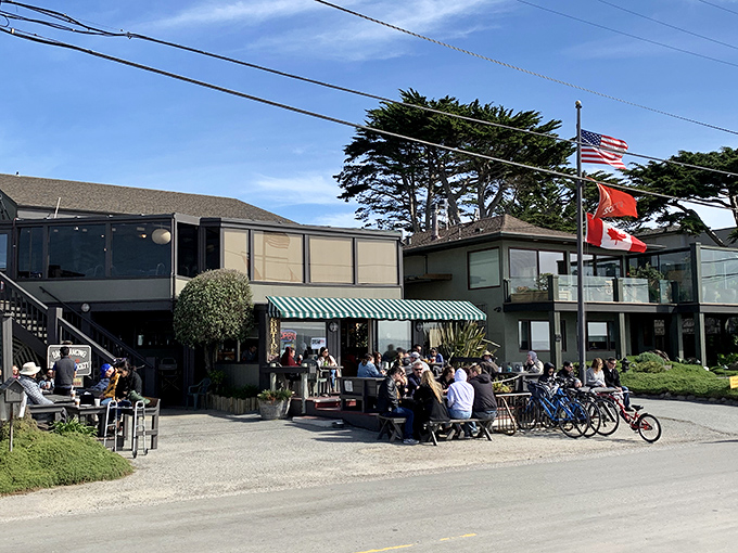 Where locals gather and visitors feel instantly welcomed. This sun-drenched patio buzzes with conversation while bikes wait patiently for their next coastal adventure. 