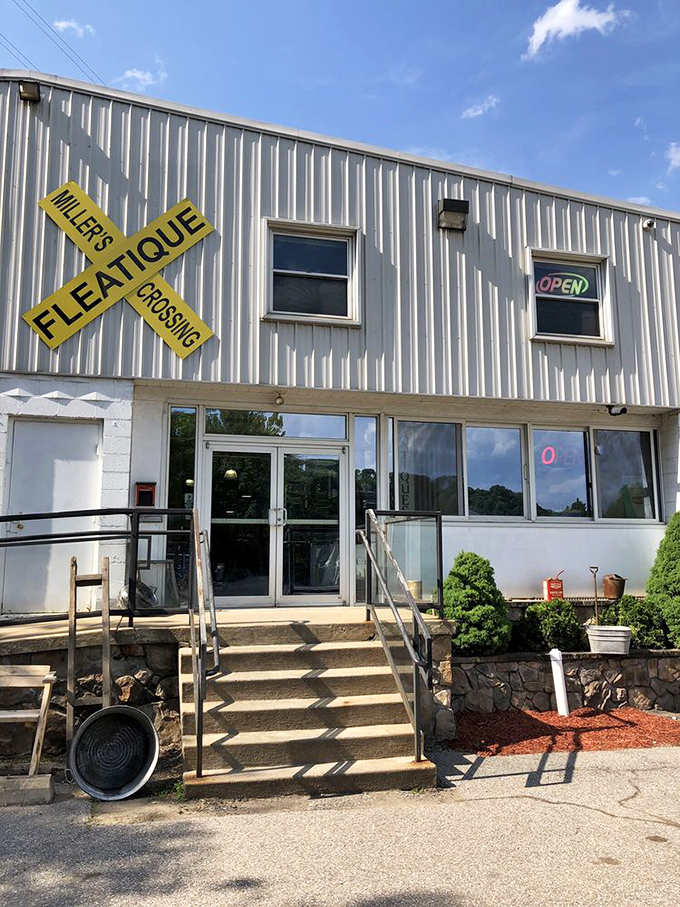 The unassuming entrance belies the wonderland within. That yellow railroad sign isn't just decoration&mdash;it's your first clue to the adventure ahead.