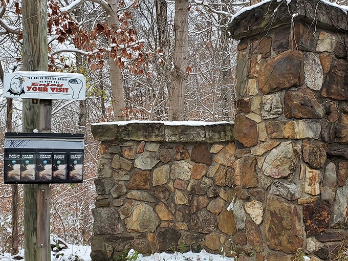 Winter transforms the preserve entrance into a Robert Frost poem come to life, where stone pillars stand guard like sentinels from another time.