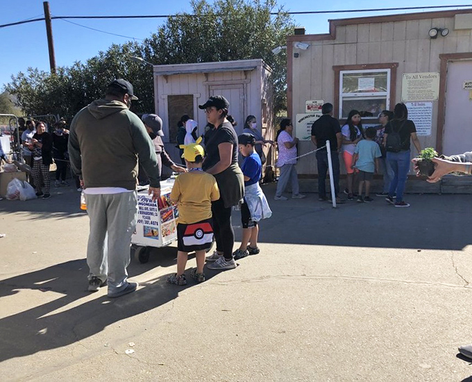 The gateway to bargain paradise. Families line up early, knowing the best deals won't wait for latecomers.