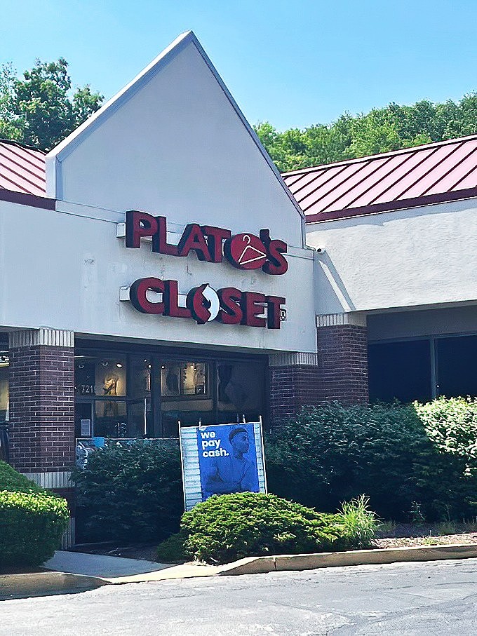Bathed in sunlight, this Plato's Closet location transforms the ordinary strip mall into a fashion hunter's paradise.