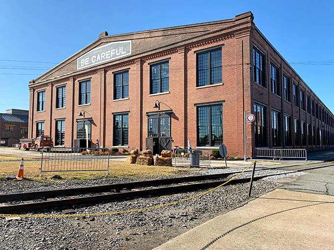BE CAREFUL warns the historic brick facade of the Back Shop building, where massive locomotives once rolled in for repairs and now house impressive exhibits.