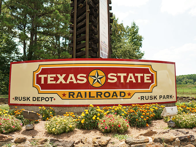 This isn't just a sign&mdash;it's your official invitation to step back in time. The colorful flower beds add a touch of warmth to the historic welcome.