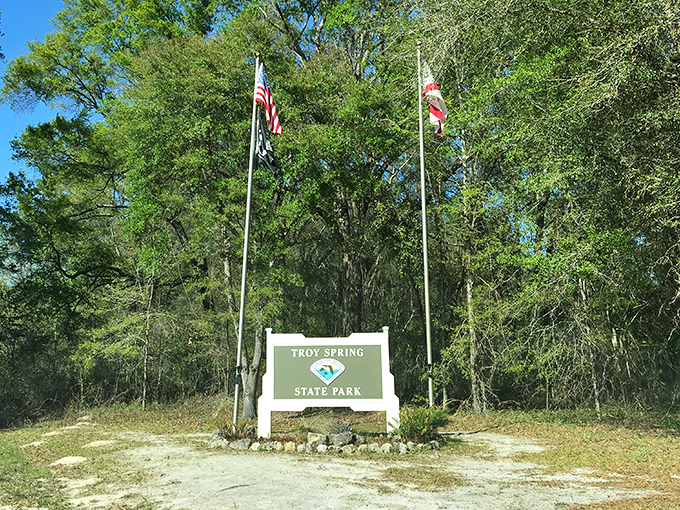 The entrance sign stands like a humble gatekeeper to paradise. No velvet rope, no dress code&mdash;just 70 feet of pristine spring water beyond.
