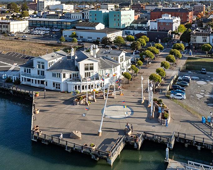 The pristine white Eureka Boardwalk building welcomes visitors to the waterfront, where California coastal living unfolds at a refreshingly unhurried pace.