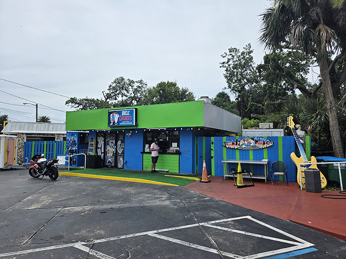 By day, this vibrant green and blue shack looks like what would happen if Jimmy Buffett designed a restaurant after a particularly inspiring beach day.