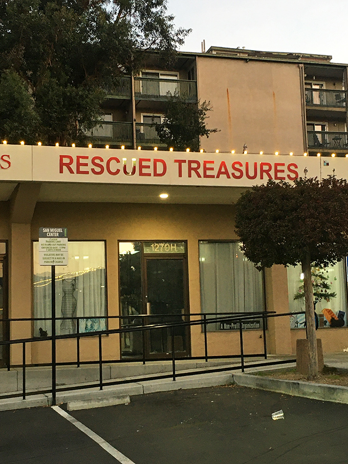 Evening lights illuminate the Rescued Treasures sign, beckoning bargain hunters like a lighthouse guiding ships to treasure-filled shores.
