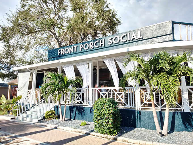 Front Porch Social isn't just a name&mdash;it's a lifestyle philosophy. White railings, tropical plants, and that Florida breeze make every meal feel like vacation.
