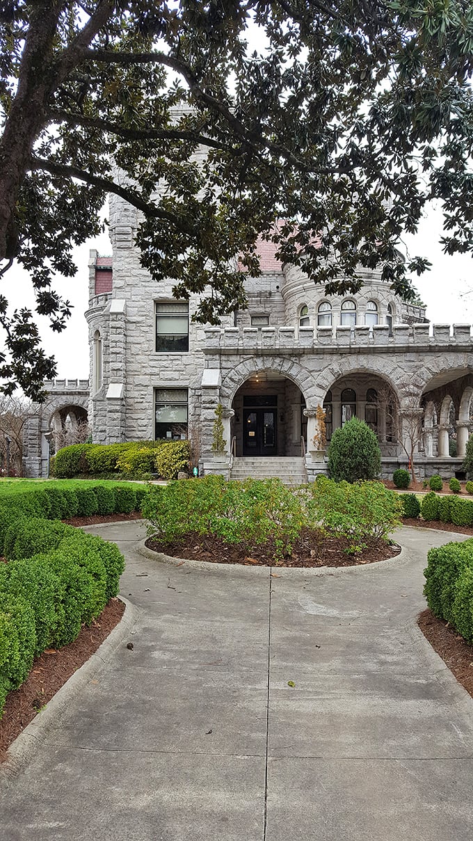 The meticulously manicured gardens frame this granite masterpiece like nature's perfect picture frame. Medieval meets Midtown in spectacular fashion.