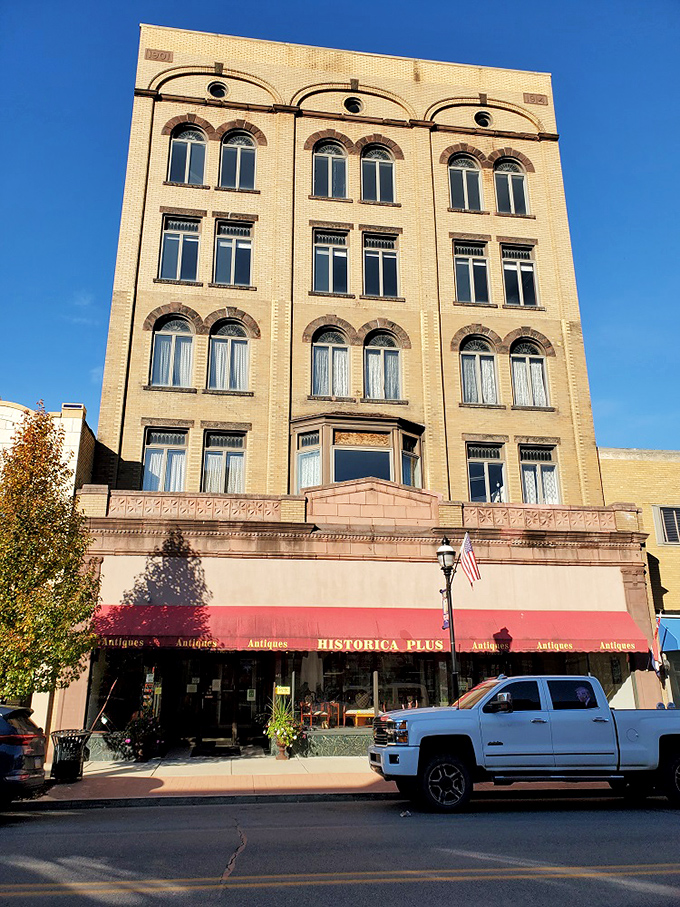 Majestic yellow brick architecture stands four stories tall, a testament to early 20th-century craftsmanship. The building itself is as much an artifact as what's inside.
