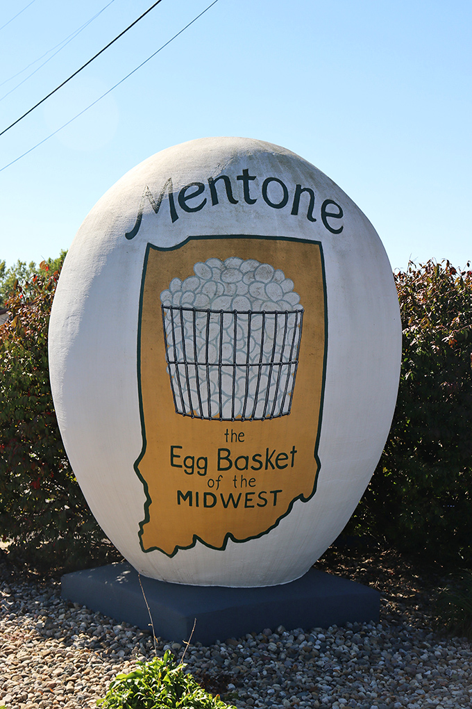 The egg's golden state outline proclaims Mentone as "The Egg Basket of the Midwest," a title worn with small-town confidence.