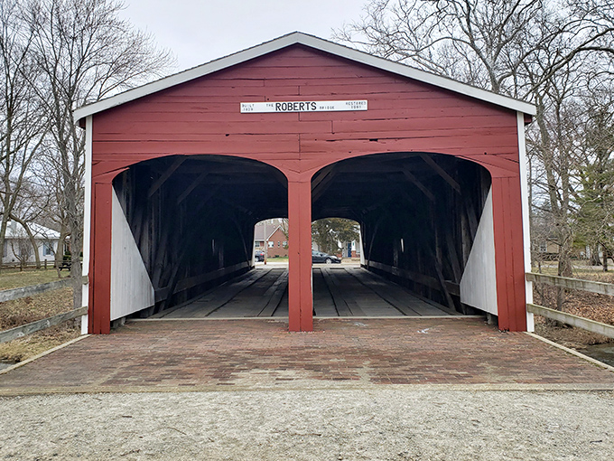 Two arched entrances welcome visitors like open arms, inviting you to step back in time where horse-drawn carriages once clip-clopped through.