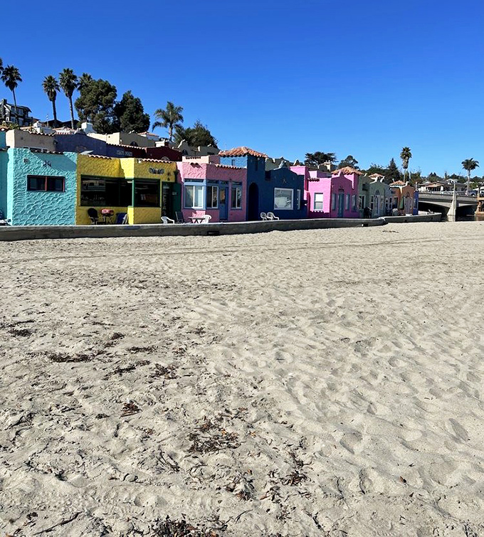 Candy-colored cottages line the sandy beachfront, proving that California beach life doesn't need to come in fifty shades of beige.
