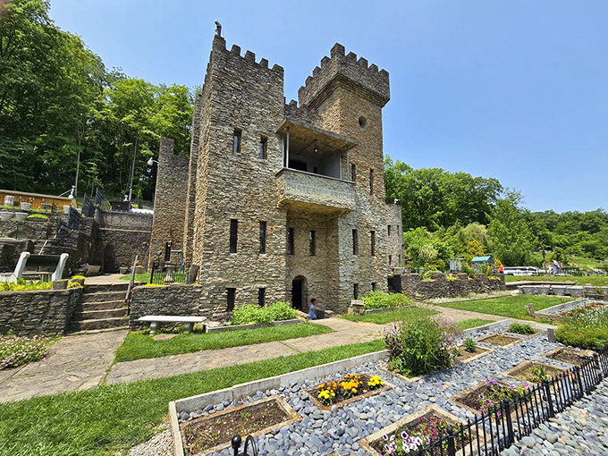 Gardens surrounding the castle offer a peaceful contrast to the imposing stone structure, with vibrant flowers and carefully arranged pathways.