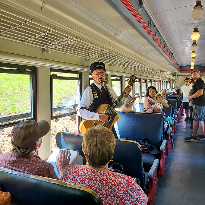 All aboard the melody express! A conductor-turned-troubadour serenades passengers, proving that the best soundtrack for nature's majesty is sometimes a simple folk tune.