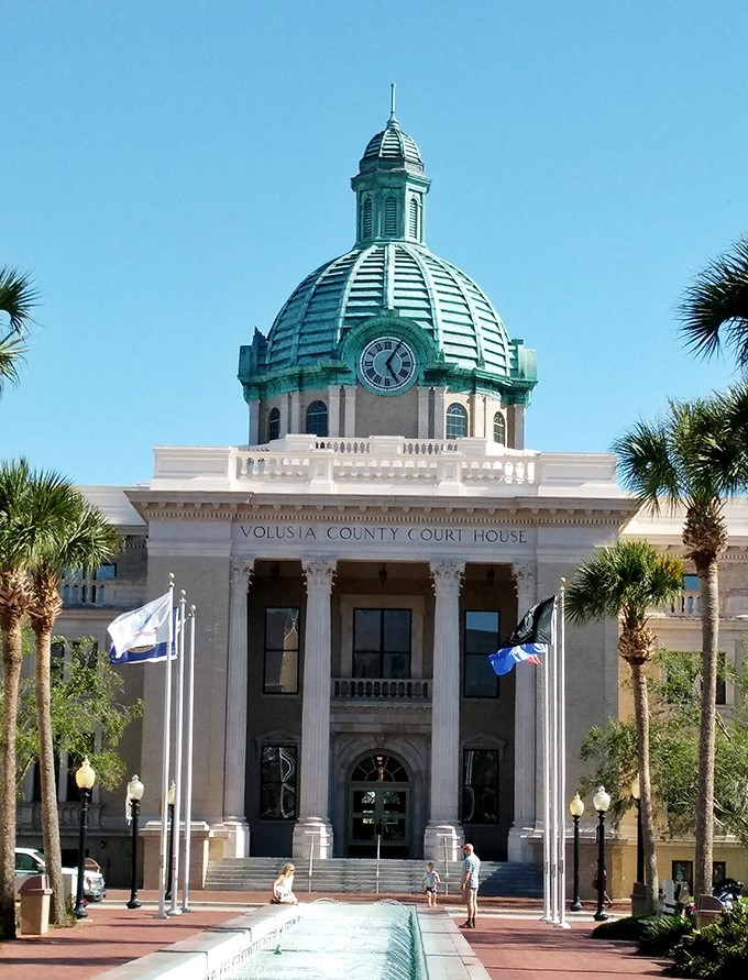 The Volusia County Courthouse stands like a wedding cake topped with that magnificent copper-green dome. Architecture that makes even paying a parking ticket feel grand.