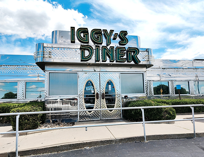 Iggy's Diner gleams like a chrome-plated time machine, its Art Deco curves and neon signage promising the kind of milkshakes that require serious straw commitment.