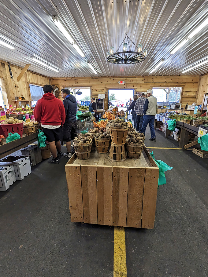 Farm-fresh abundance awaits in the rustic produce section, where wooden baskets overflow with Pennsylvania potatoes and seasonal vegetables that put supermarket offerings to shame.