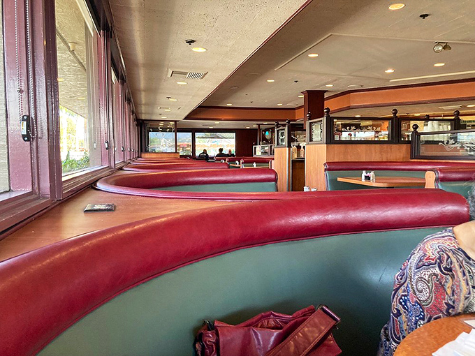 Those curved red booths aren't just seats &ndash; they're your personal comfort pods for the feast ahead.