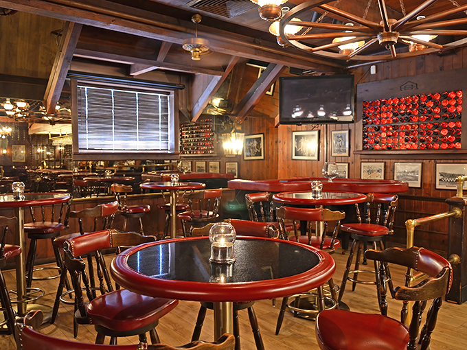 Step inside and time slows down. Rich wood paneling, wagon wheel chandeliers, and those signature red-trimmed tables create the steakhouse atmosphere of your dreams.