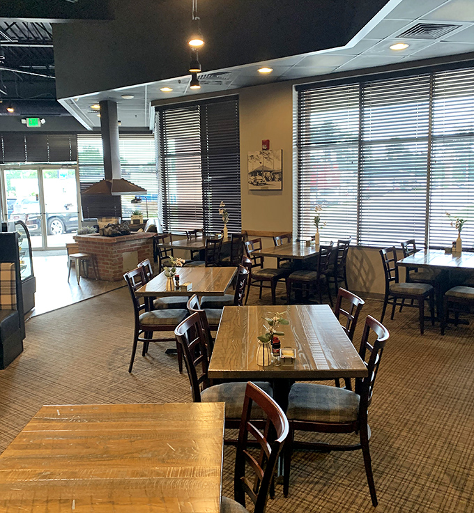 Wooden tables bathed in natural light create that rare dining atmosphere where conversations flow as smoothly as the coffee refills.