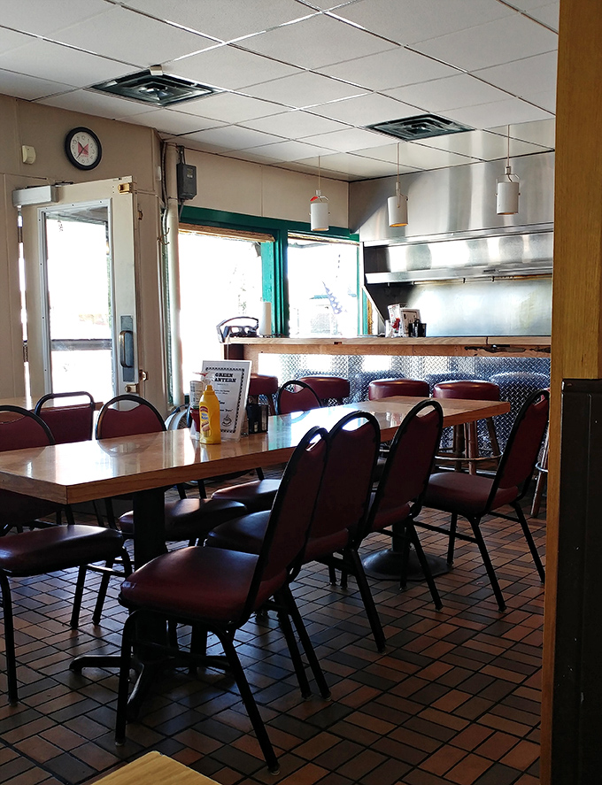 Simple burgundy chairs and no-nonsense tables &ndash; this isn't Instagram bait, it's a temple of honest cooking where calories are counted only in smiles.