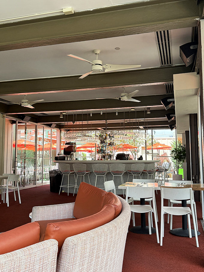 Mid-century modern meets contemporary cool in the rooftop lounge, where curved seating and airy spaces create the perfect backdrop for culinary adventures.